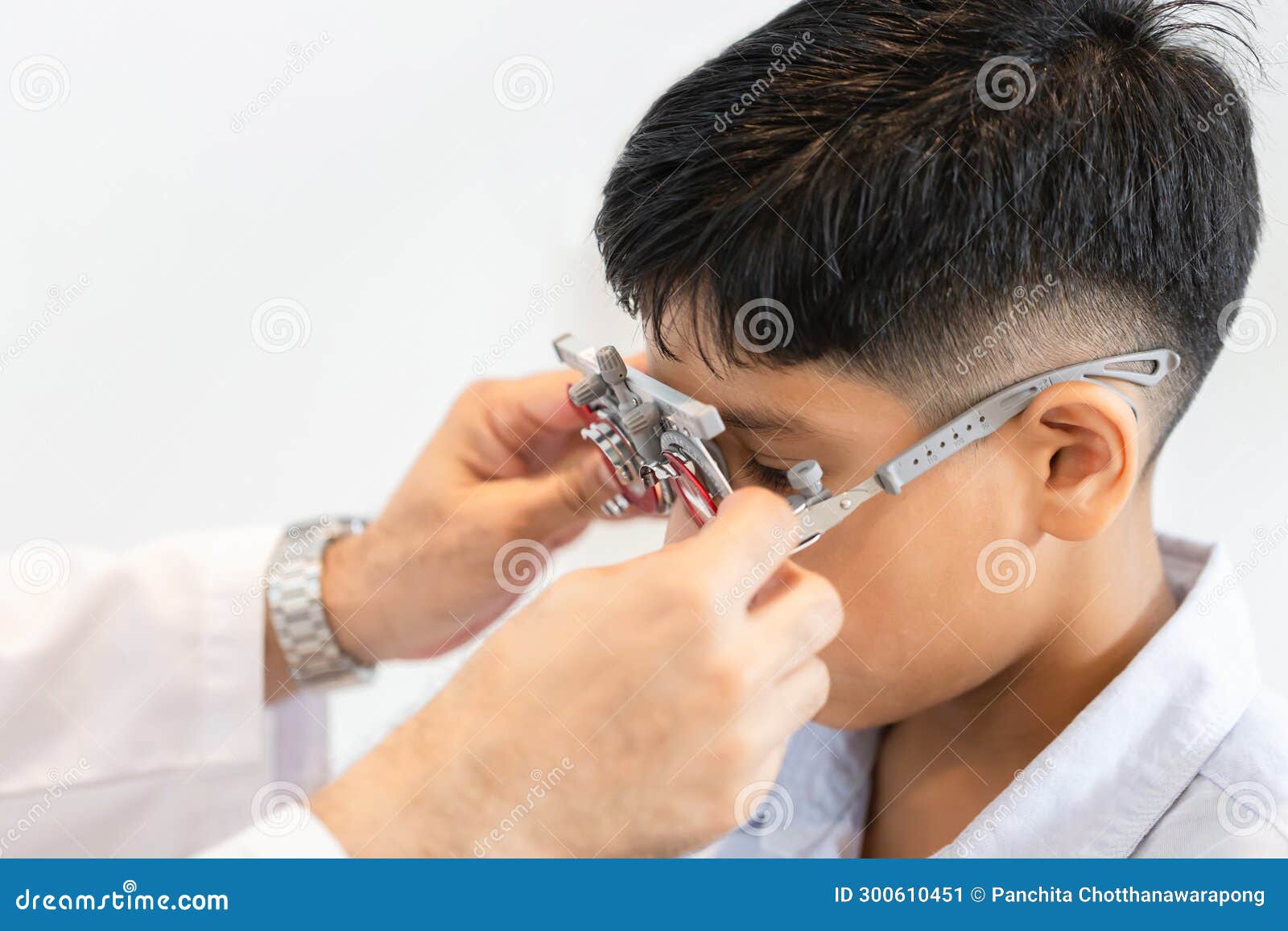 Boy Doing Eye Test Checking Examination with Optometrist in Optical ...