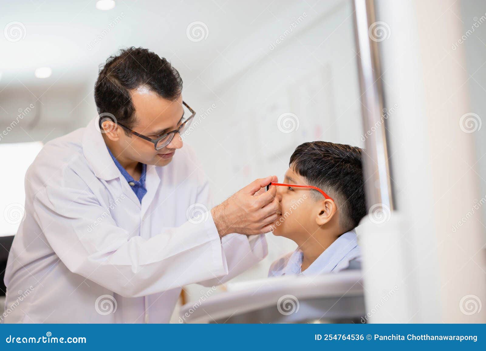 Boy Doing Eye Test Checking Examination with Optometrist Using Trial ...