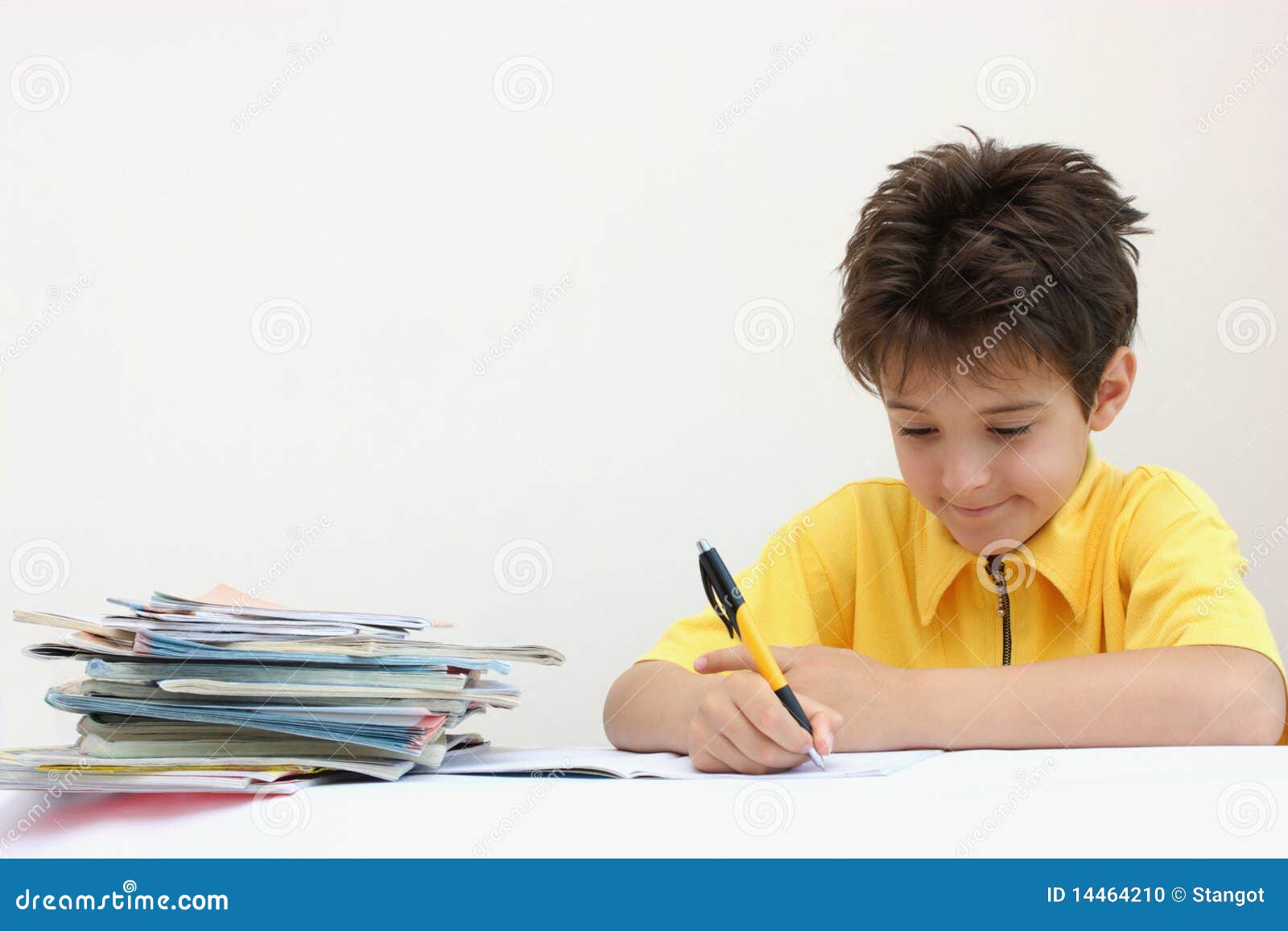 A boy doing his homework stock photo. Image of color - 14464210