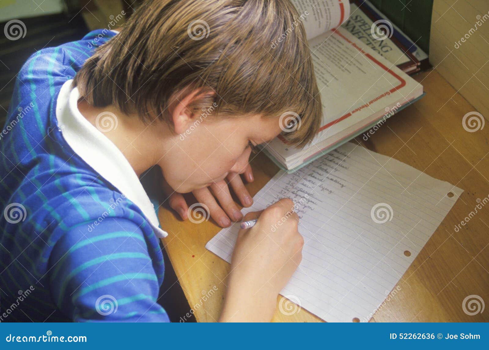 A boy doing his homework editorial photo. Image of book - 52262636