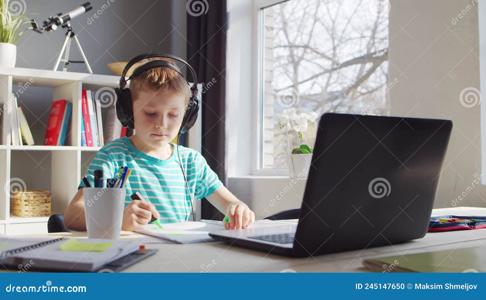 Boy is Doing His Homework at the Table. Cute Child is Learning at Home ...