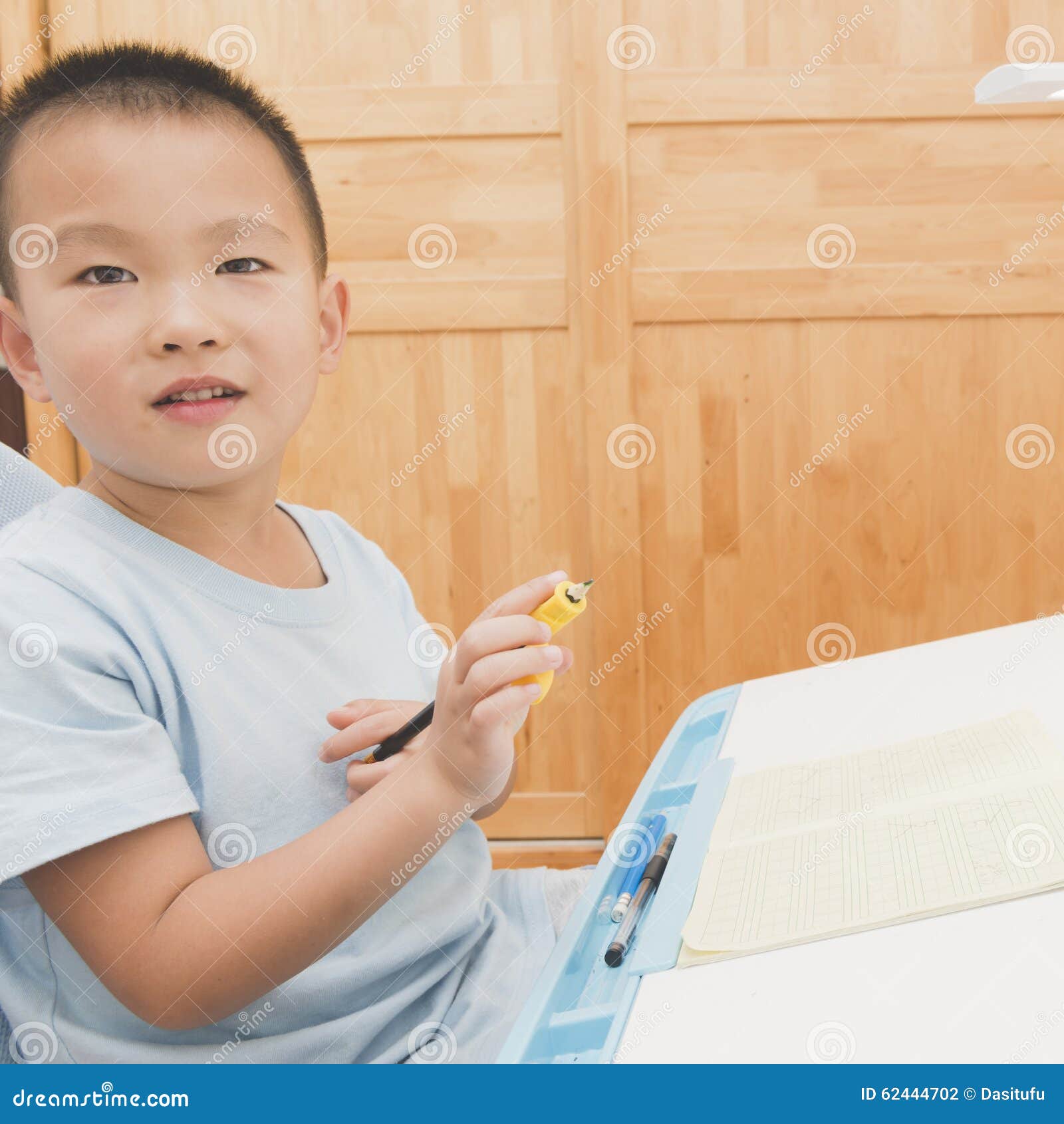 Boy doing homework stock photo. Image of paper, asian - 62444702