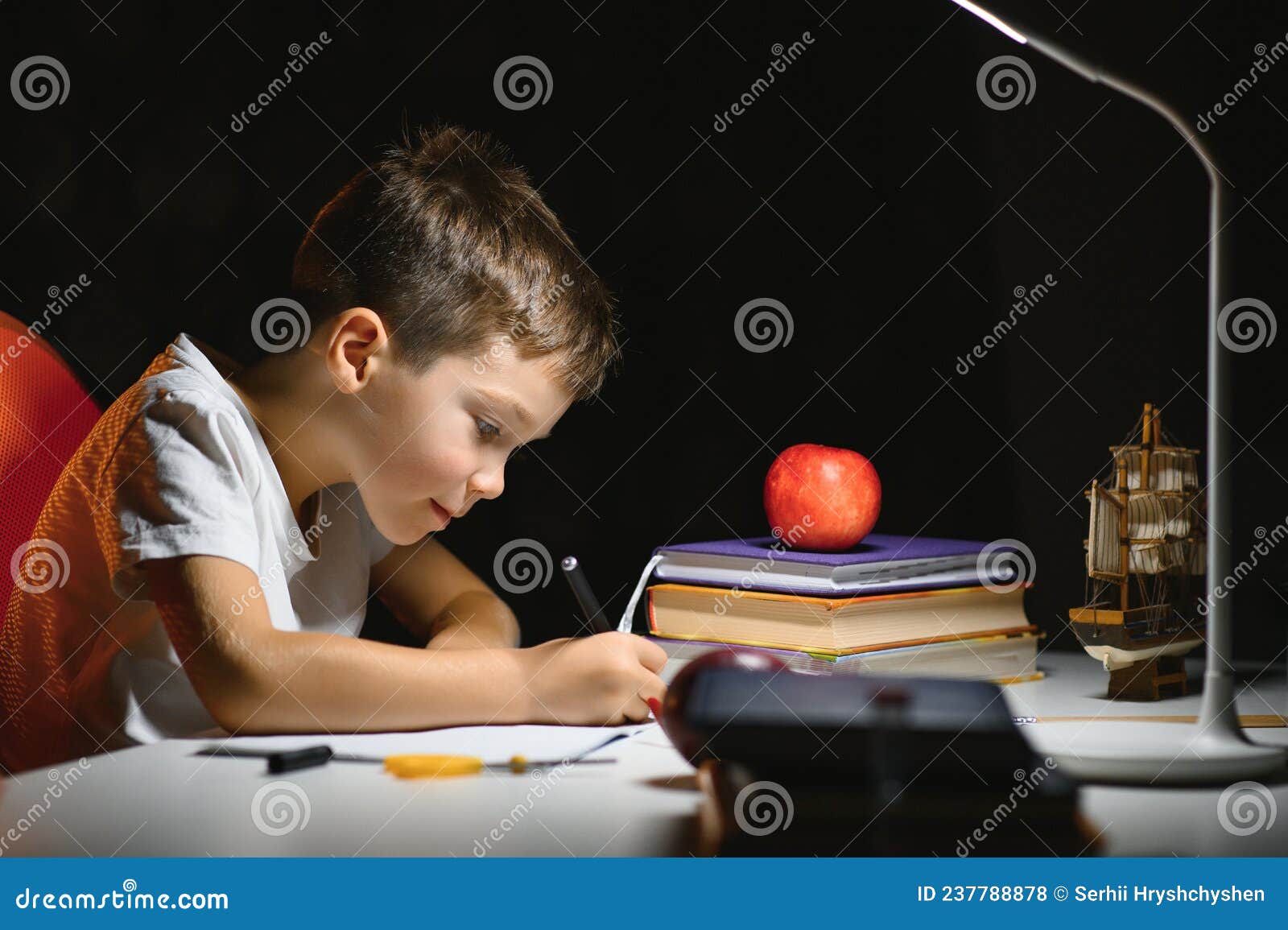 Boy Doing Homework at Home in Evening Stock Photo - Image of table ...
