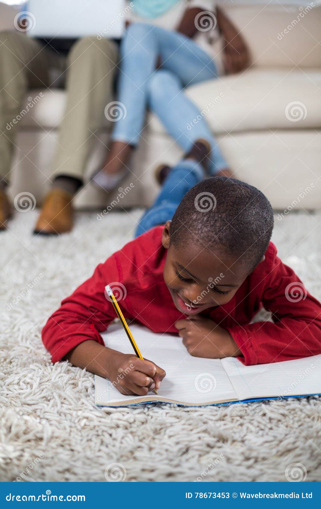 Boy Doing Homework while Lying on the Floor Stock Image - Image of ...