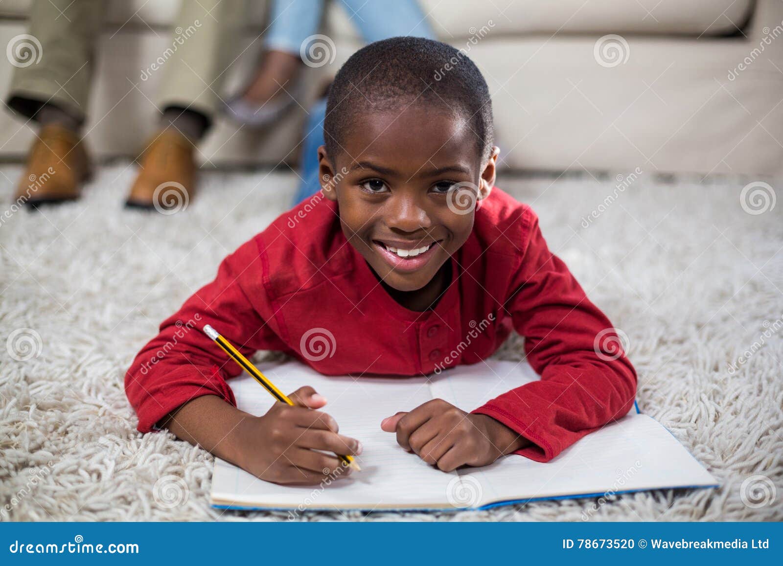 Boy Doing Homework while Lying on the Floor Stock Photo - Image of ...