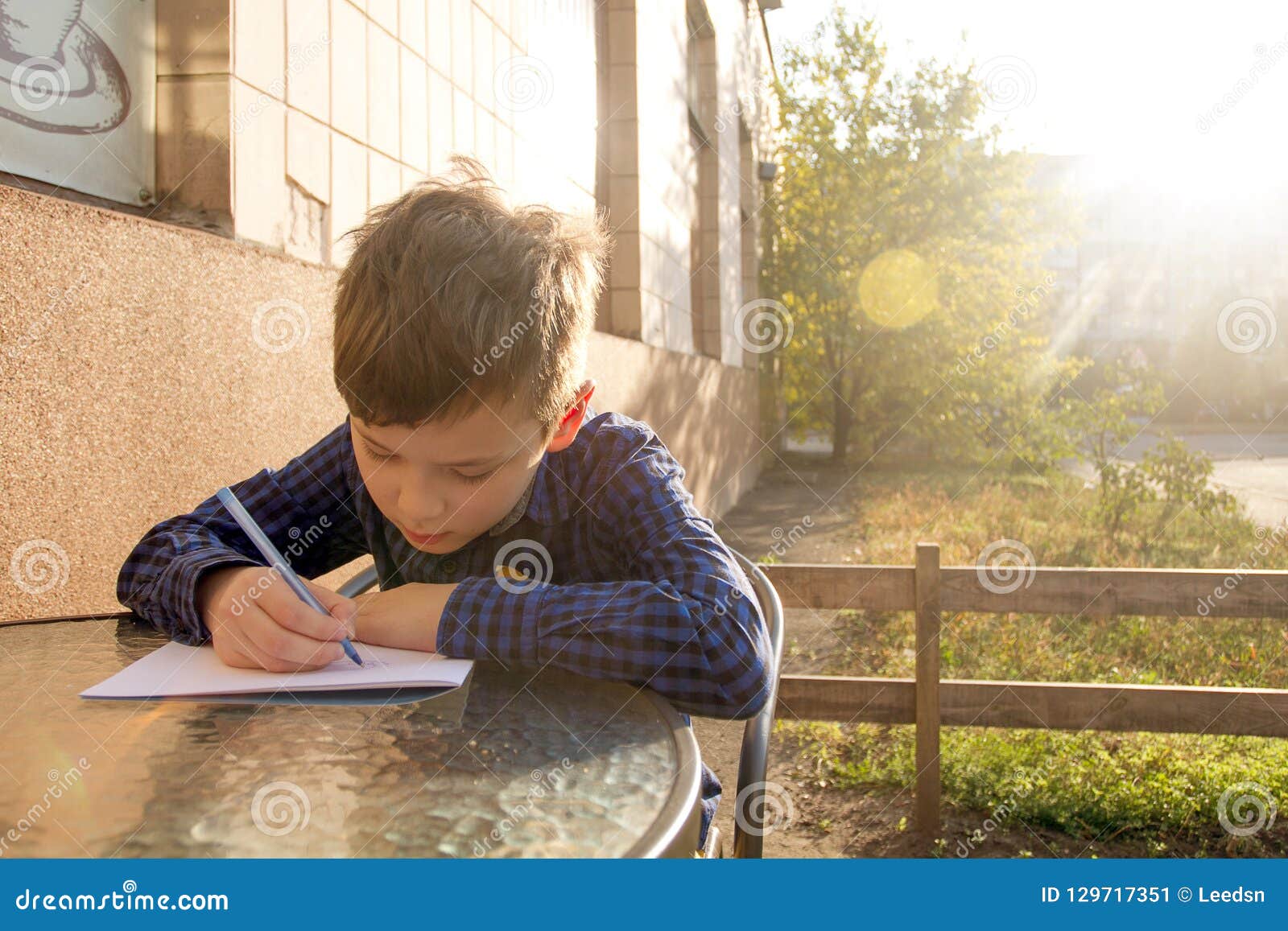 Boy is Doing Homework Outdoors Stock Image - Image of letter, outdoor ...