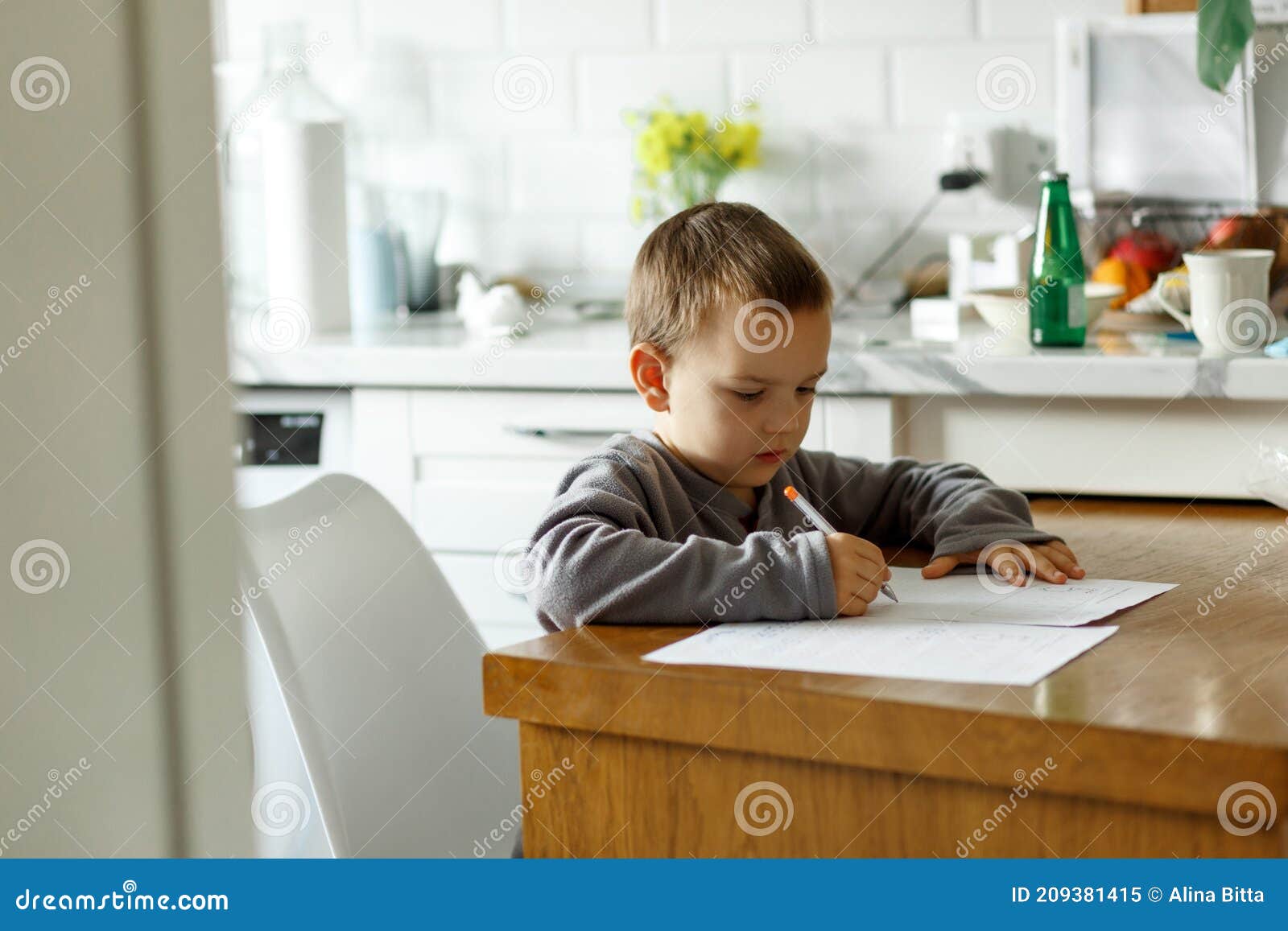 Boy Doing Homework Sitting at Kitchen Table Stock Image - Image of male ...