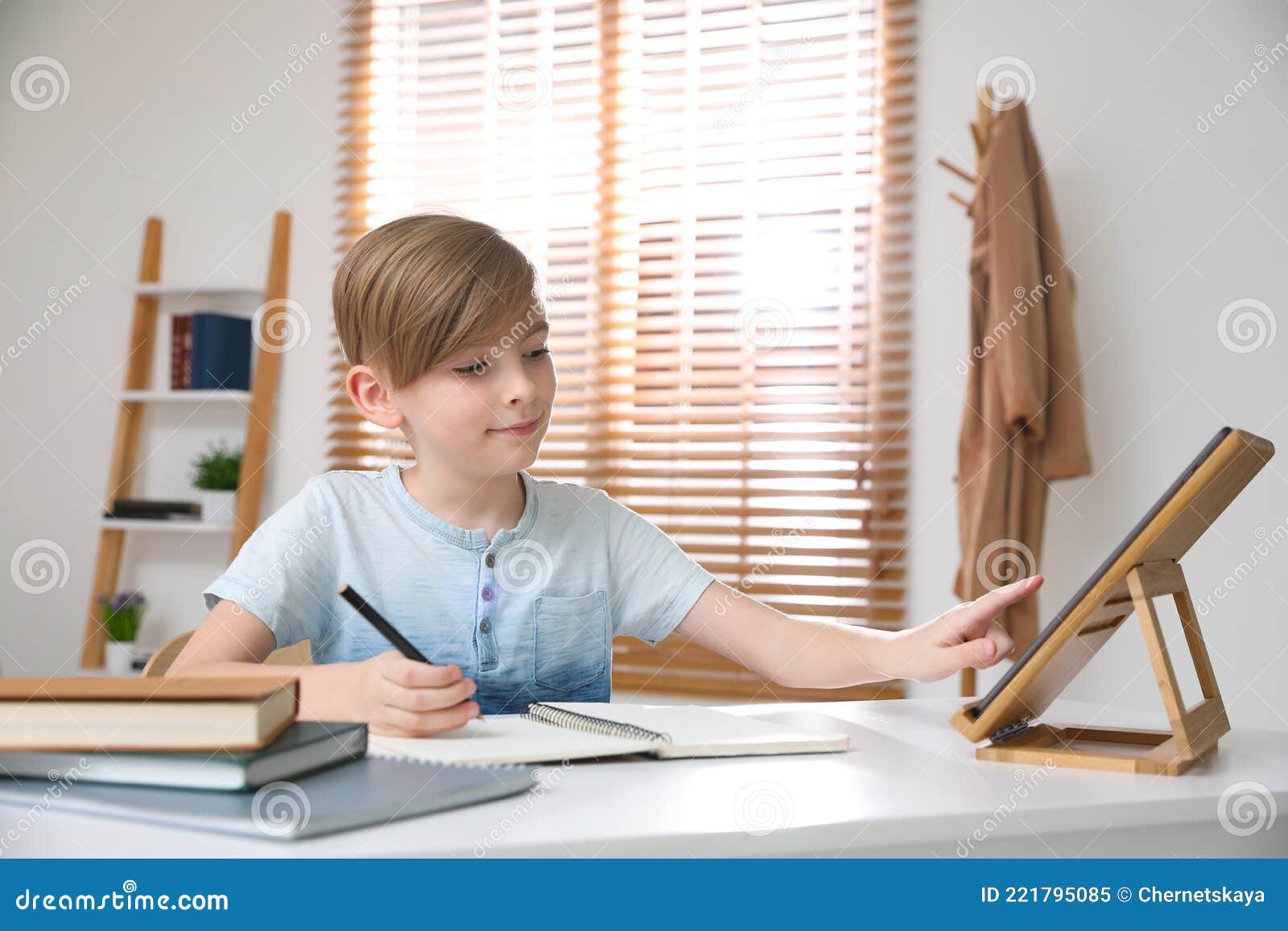 Boy Doing Homework with Tablet at Table Stock Image - Image of computer ...