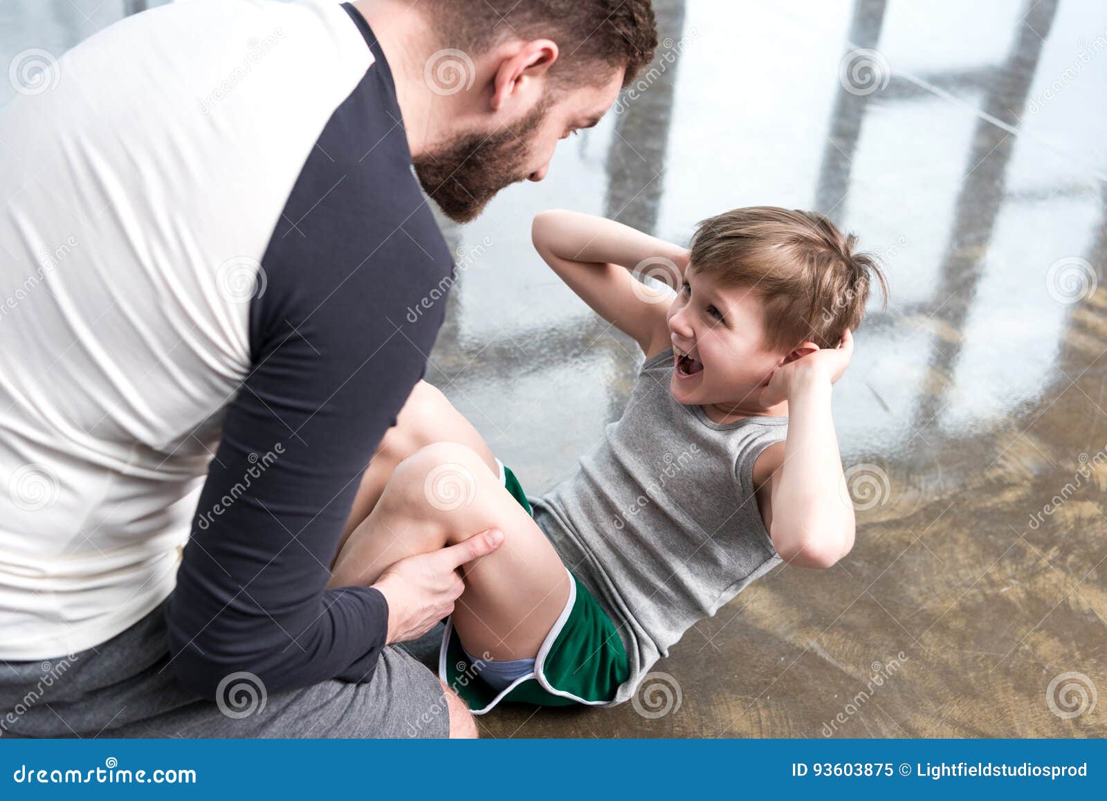 Boy Doing Sit-ups while Trainer Holding Feet Stock Image - Image of ...