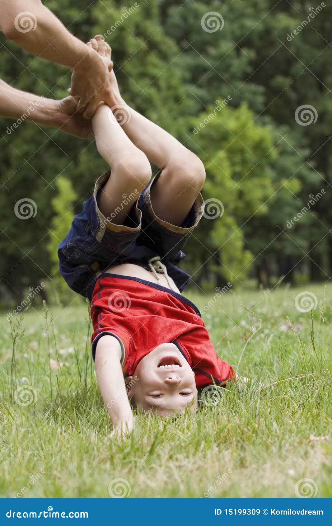 Boy doing upside down stock image. Image of grass, acrobat - 15199309