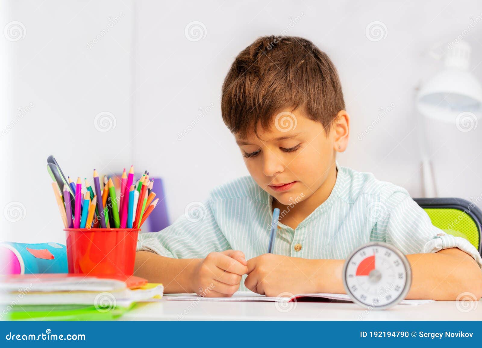 Boy Doing Writing Exercise on Time at Class Stock Photo - Image of ...