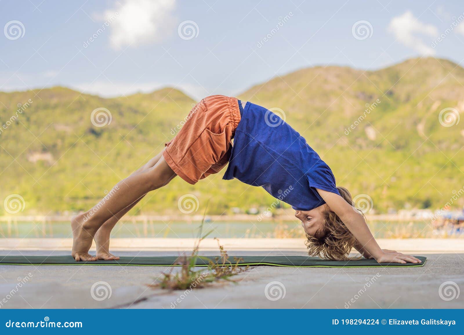 Boy Doing Yoga on a Yoga Mat Against a Background of Mountains Stock ...