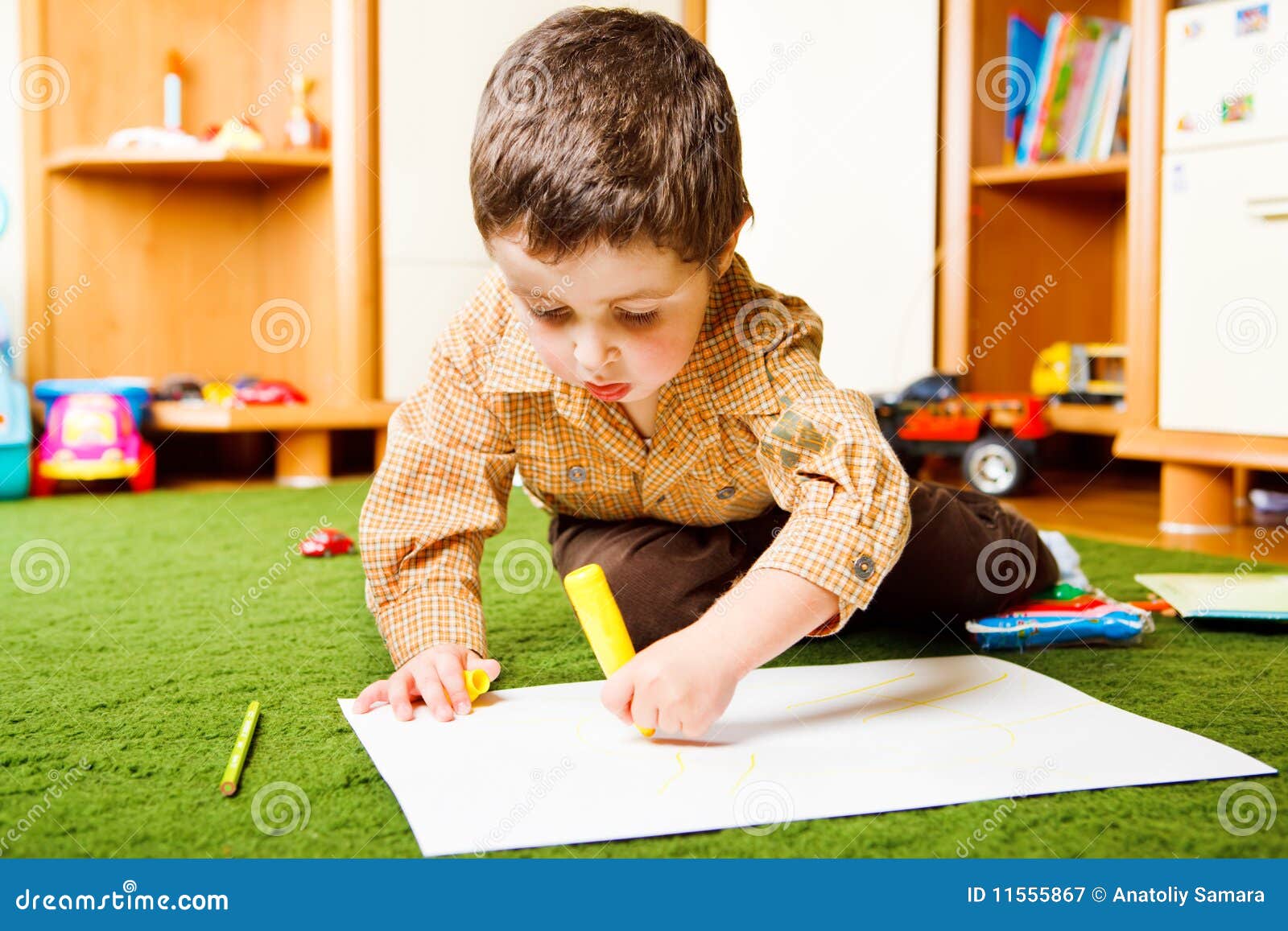 Boy drawing a picture stock image. Image of paper, laying - 11555867