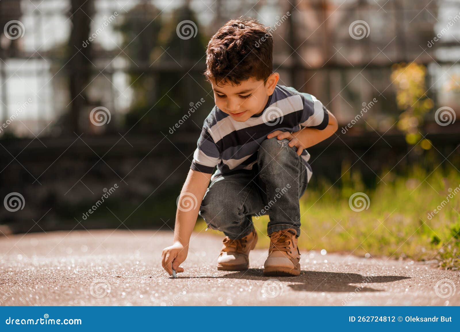 Boy Drawing Something on the Ground Stock Photo - Image of darkhaired ...