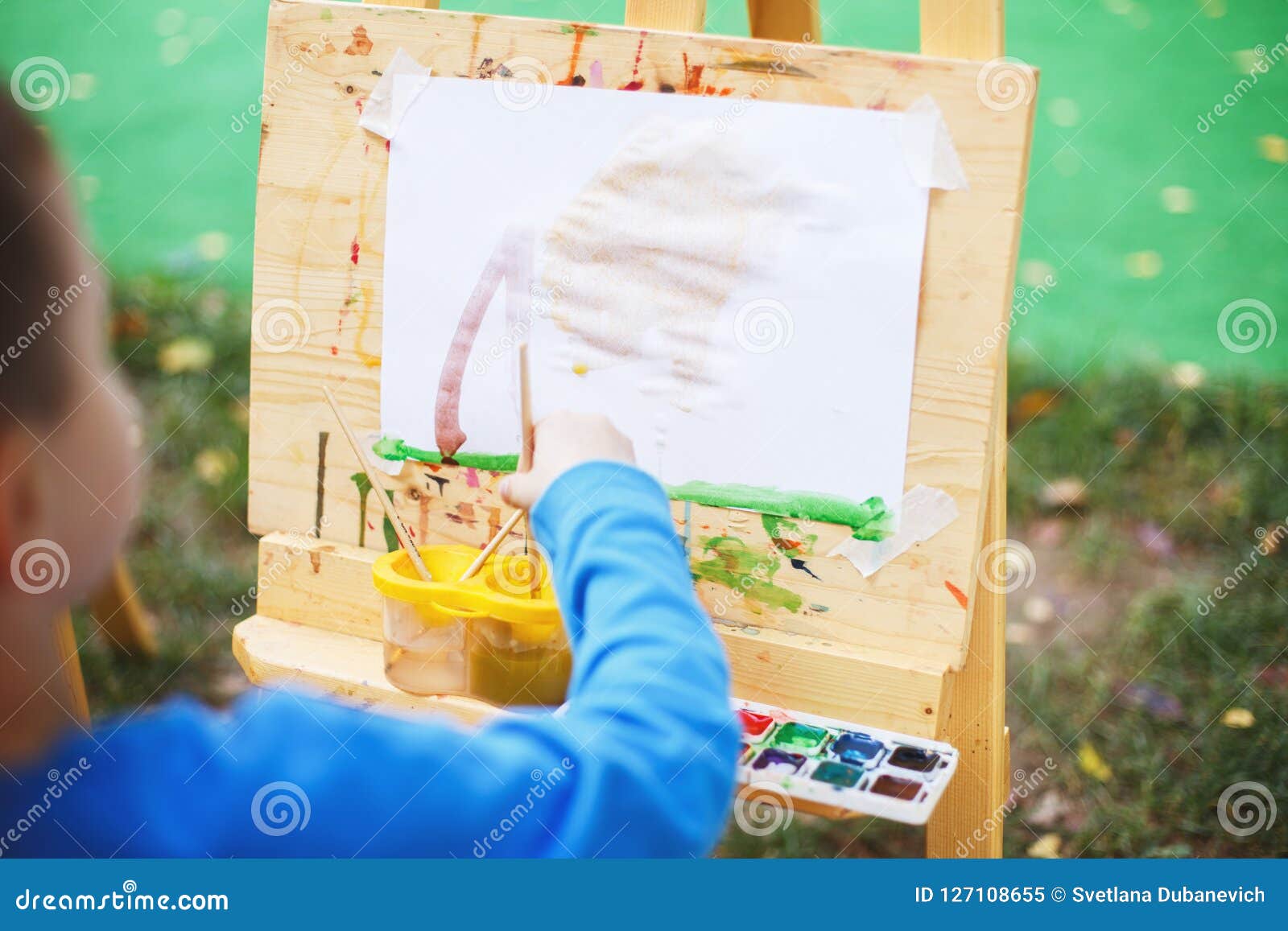 Boy draws on the easel. stock image. Image of canvas - 127108655
