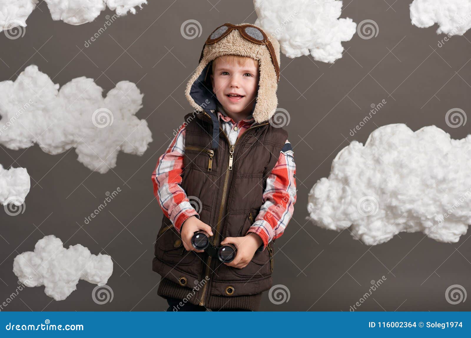Boy Dressed As an Airplane Pilot Stands between the Clouds and Looks ...