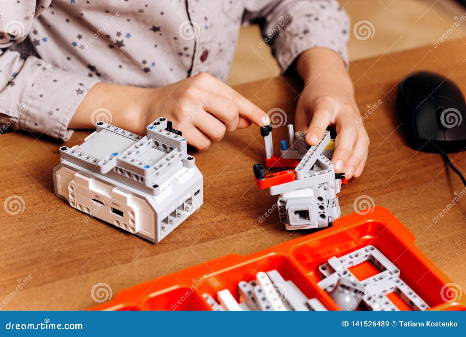 Boy Dressed in Gray Shirt Makes a Robot from the Robotic Constructor at ...
