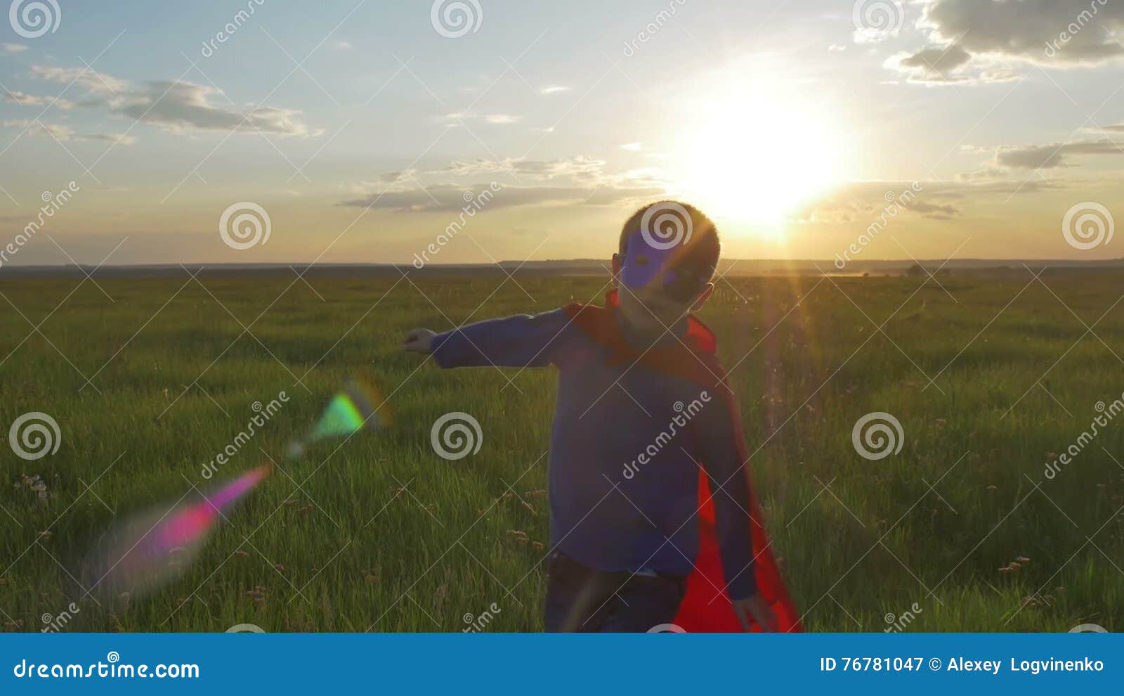 Boy Dressed with a Superman Cape Running in a Field, Looking into the ...