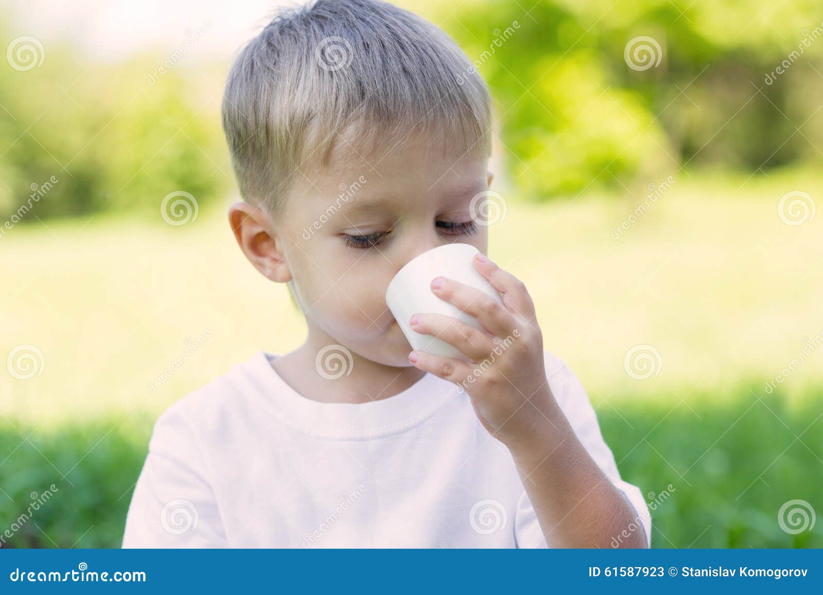 Boy drinking from a cup stock image. Image of healthy - 61587923