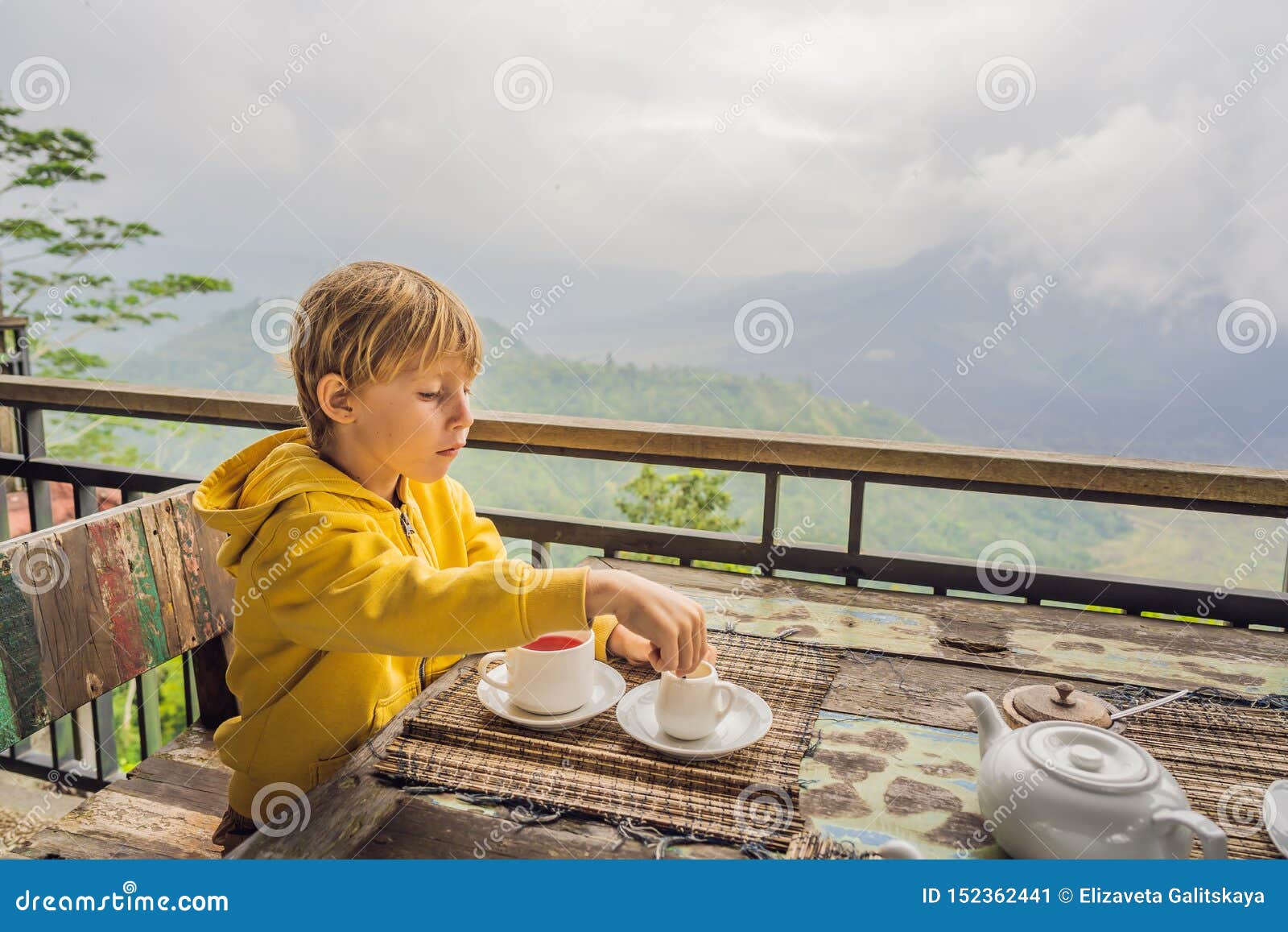 Boy Drinking Tea in a Cafe in the Mountains Stock Image - Image of ...