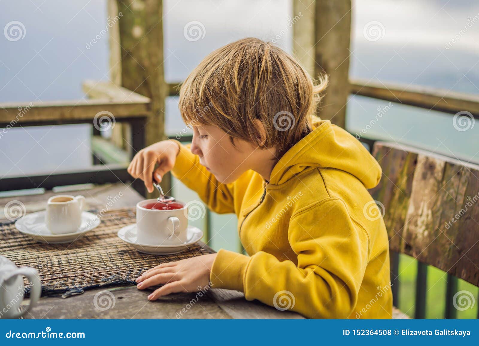 Boy Drinking Tea in a Cafe in the Mountains Stock Photo - Image of ...