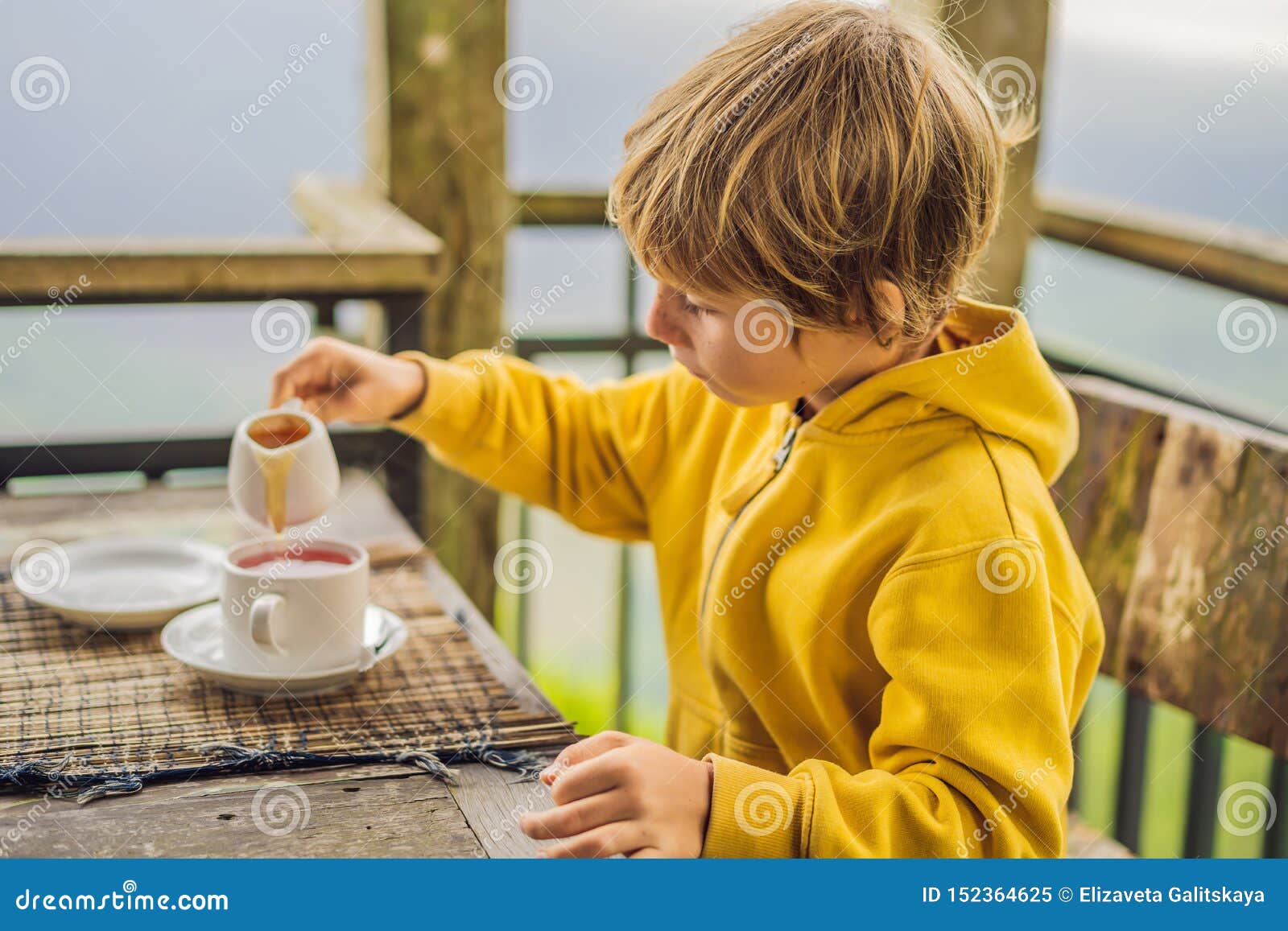 Boy Drinking Tea in a Cafe in the Mountains Stock Image - Image of ...