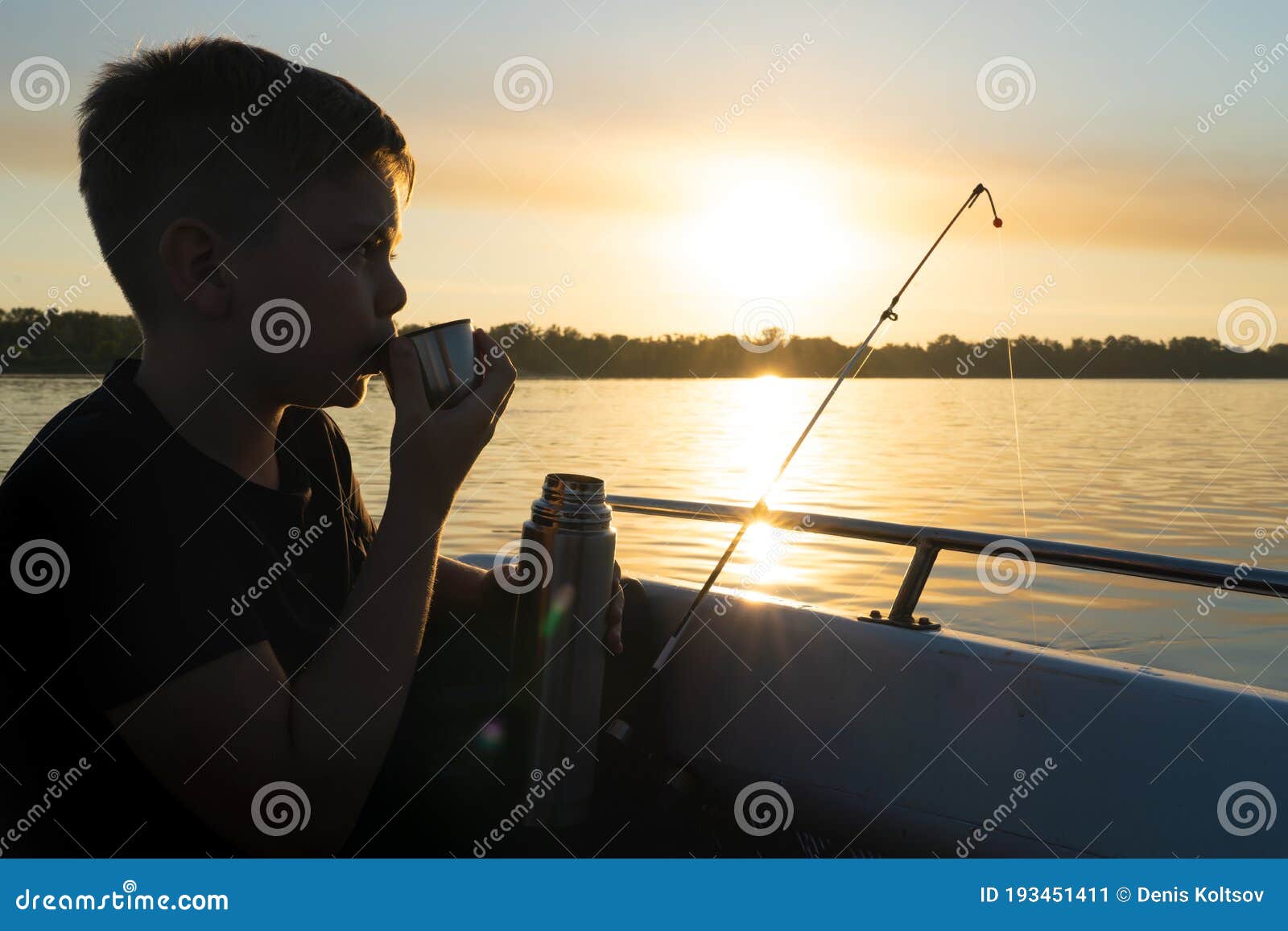 The Boy is Drinking Tea from a Thermos while Fishing. Stock Image ...