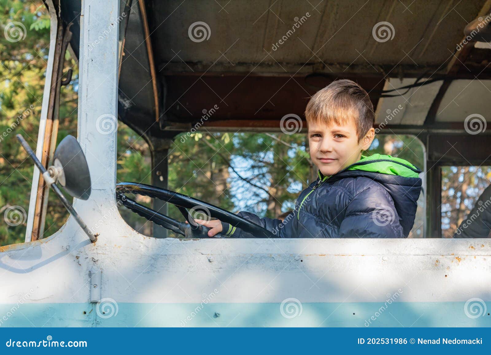 A Boy Drive a Bus. the Boy Turns the Steering Wheel in the Abandoned ...