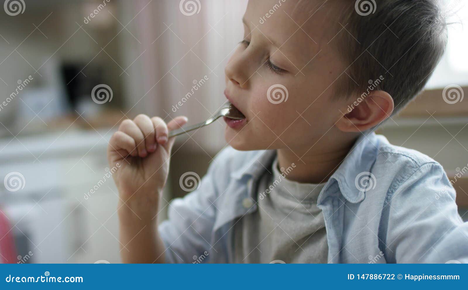 Boy Eat Piece of Bread with Chocolate Paste after the Dinner Close Up ...