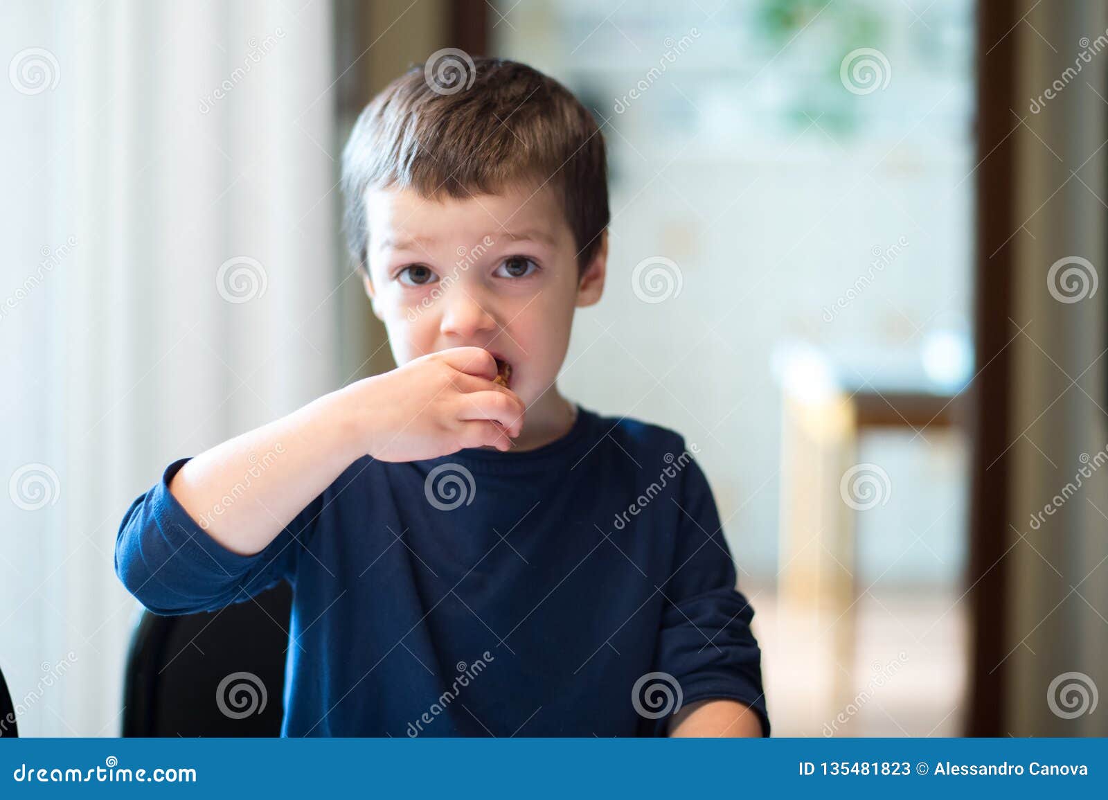 A boy eat some bread stock image. Image of children - 135481823
