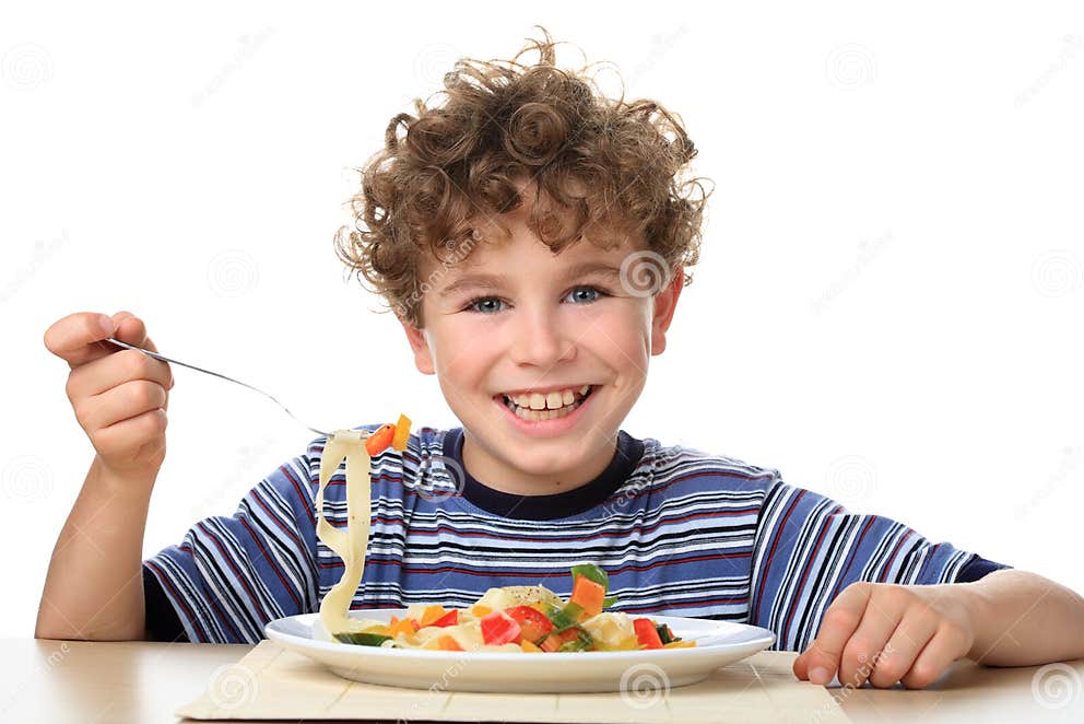 Boy eating stock image. Image of hunger, tasty, fork, table - 3284419