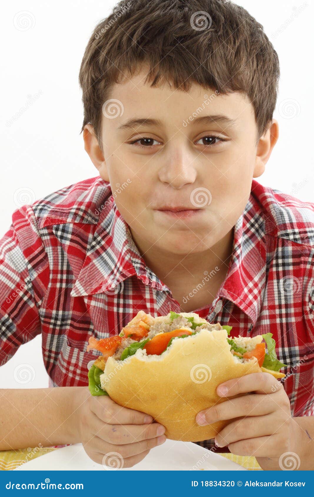 Boy eating a big hamburger stock photo. Image of isolated - 18834320