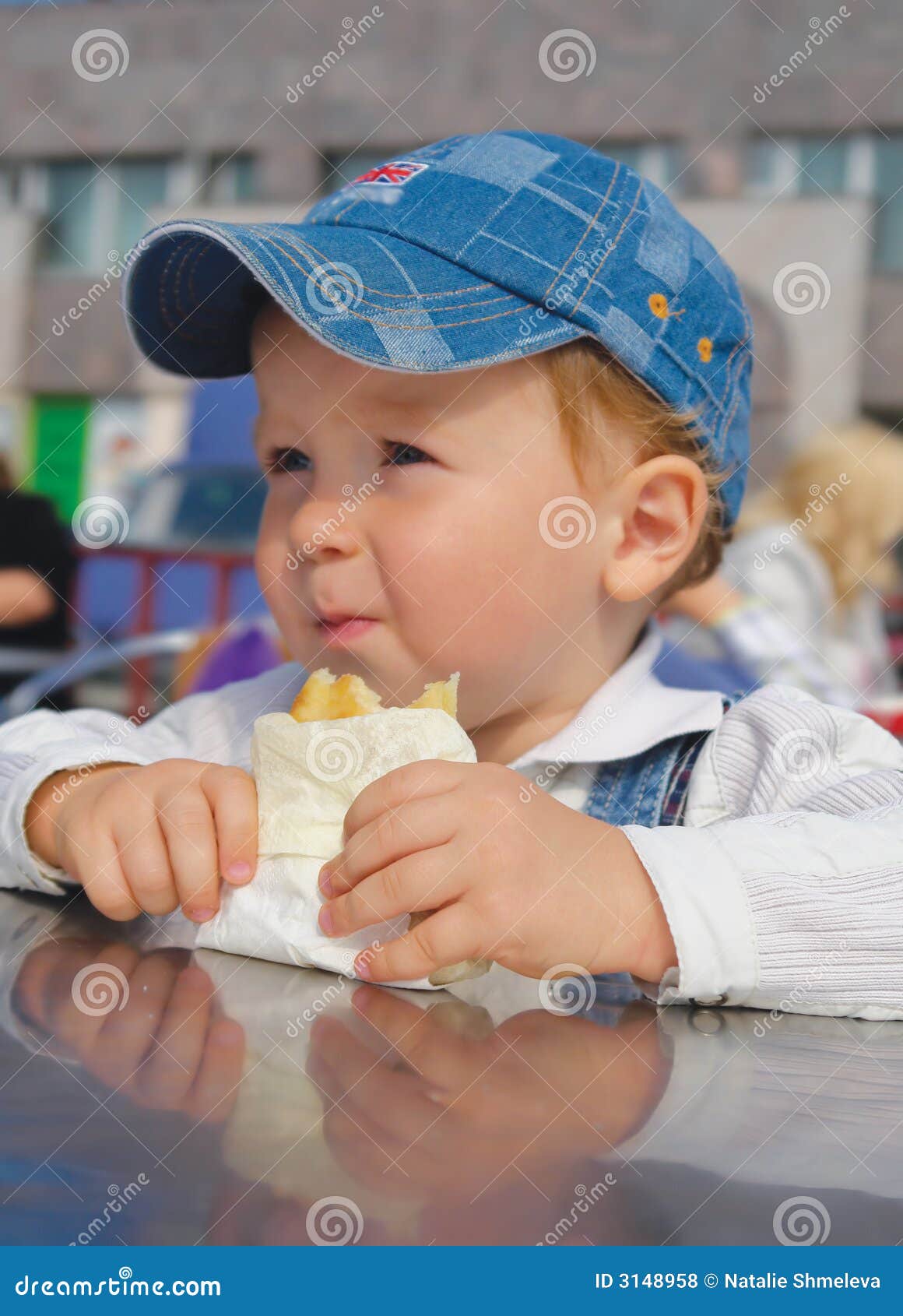 Boy eating cake stock photo. Image of outdoors, table - 3148958