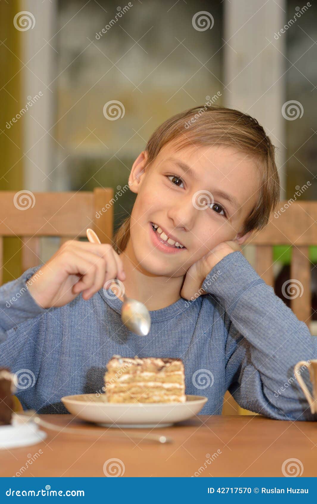 Boy eating cake at home stock photo. Image of team, meat - 42717570