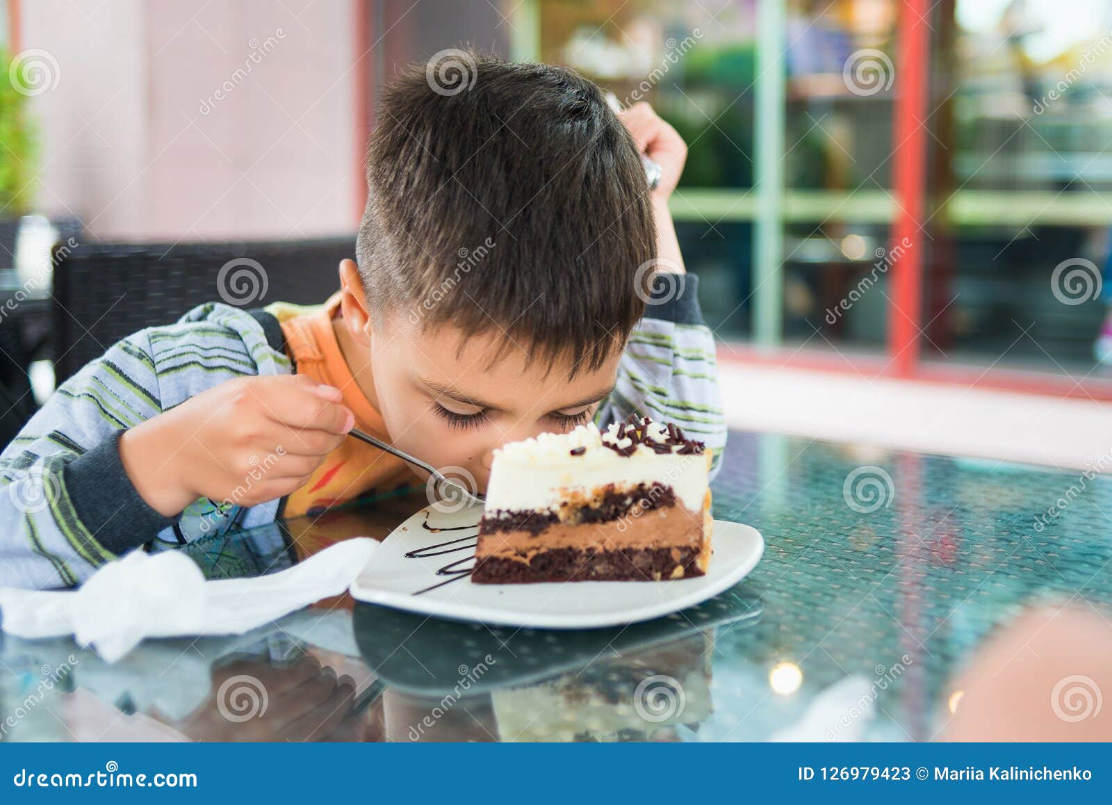 Boy Eating a Cake Low Bent Over Plate in Cafe Stock Image - Image of ...