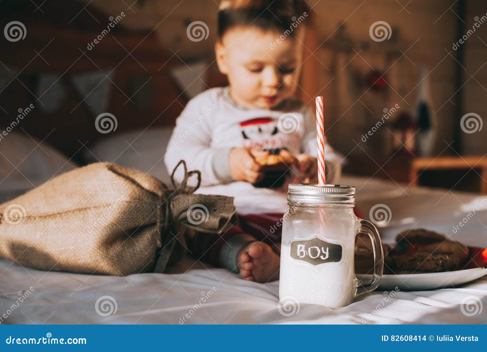 Boy eating cookies in bed stock photo. Image of home - 82608414