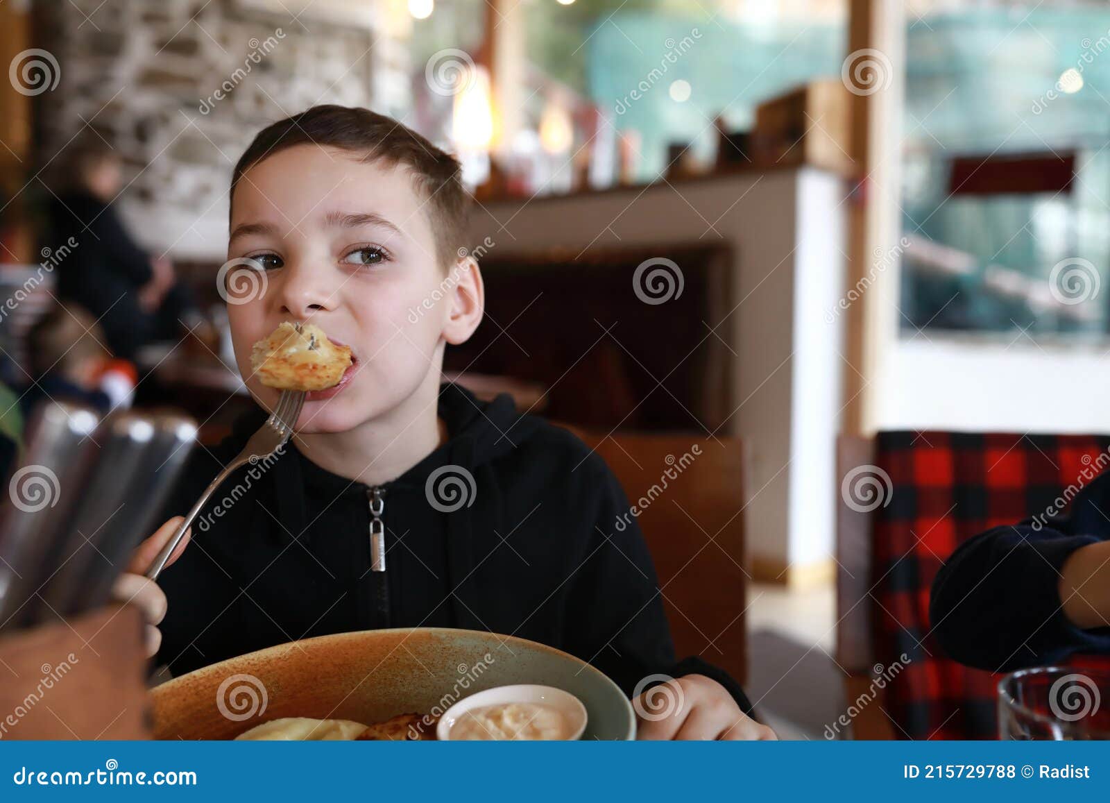Boy Eating Cutlet in Restaurant Stock Photo - Image of food, face ...