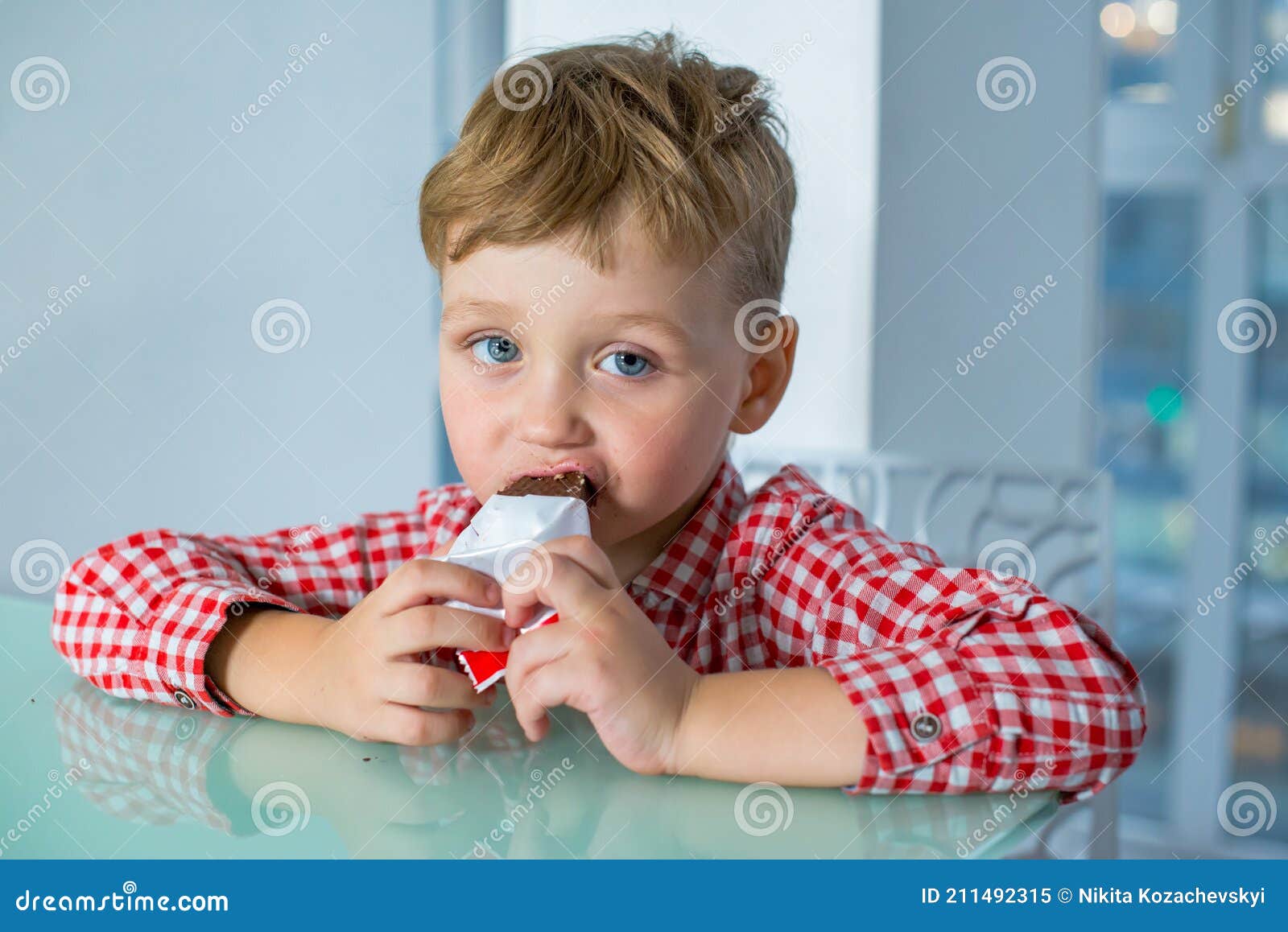Boy Eating Delicious Chocolate Bar in Kitchen Stock Image - Image of ...