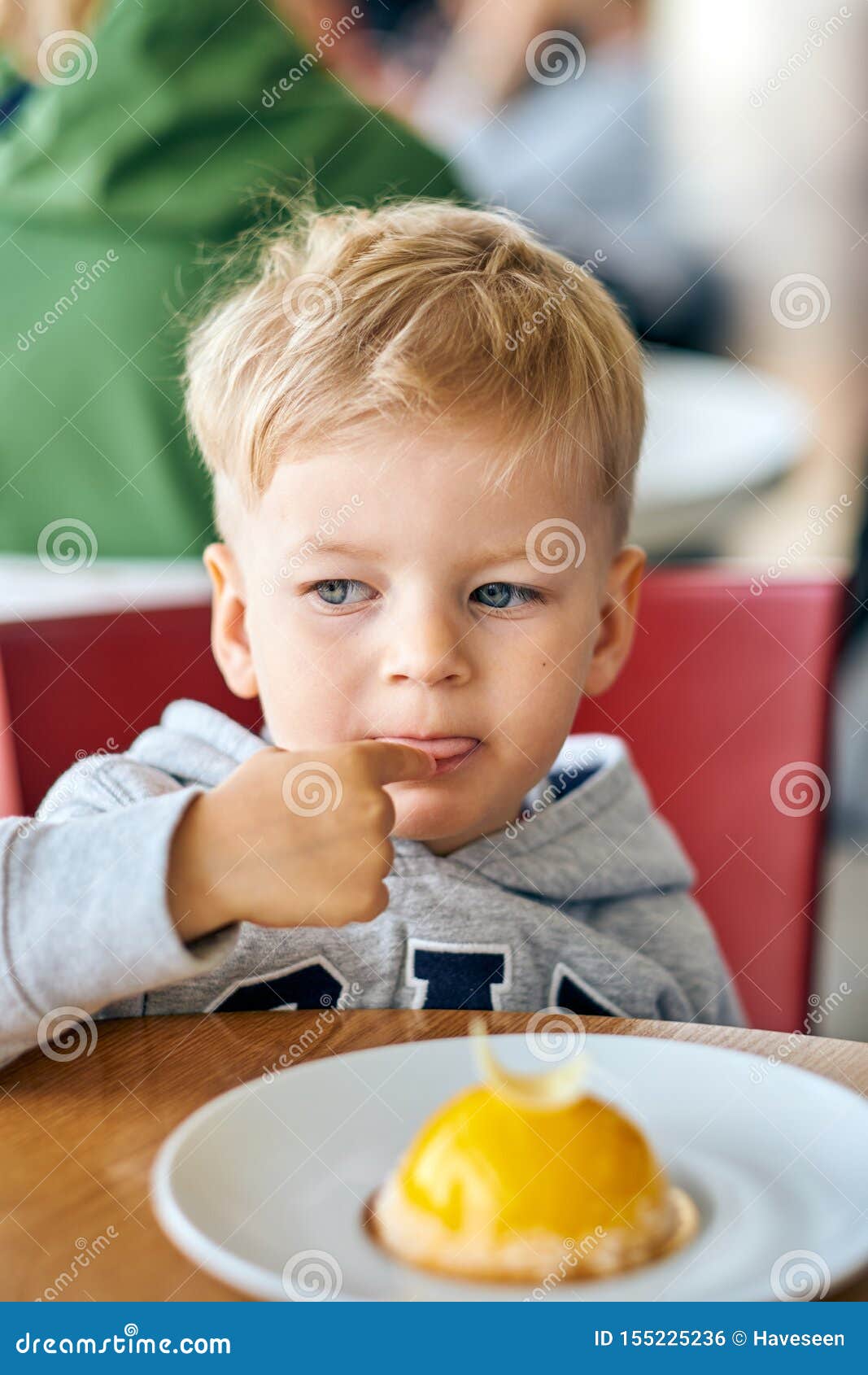Boy eating dessert in cafe stock photo. Image of human - 155225236