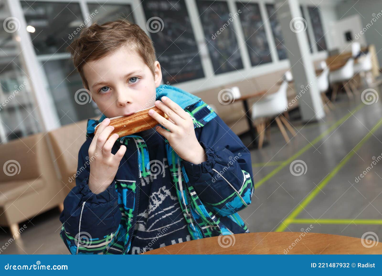 Boy Eating Eclair in Restaurant Stock Photo - Image of eating, food ...