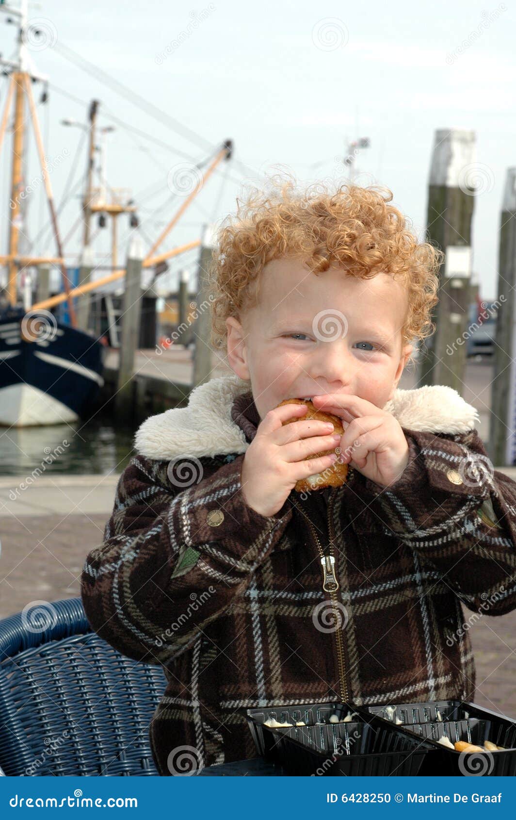 Boy eating Fish in Harbour stock photo. Image of fish - 6428250