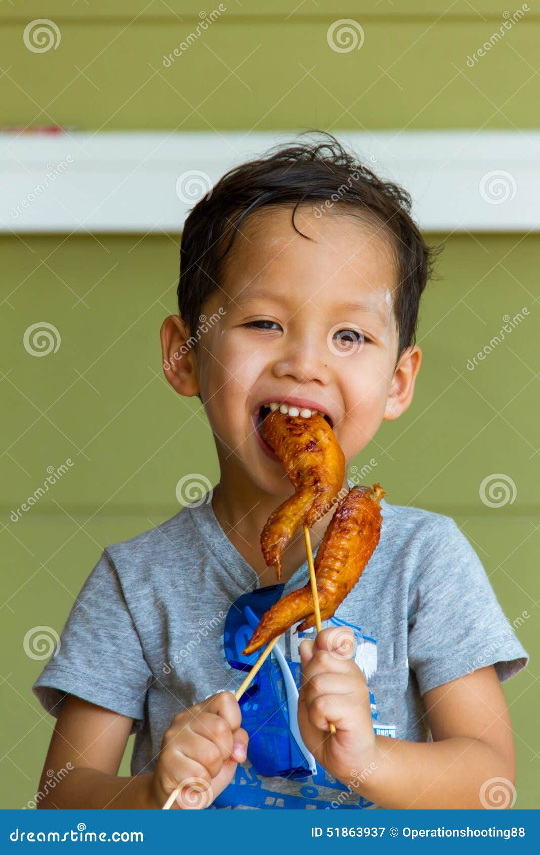 Boy eating grilled chicken stock image. Image of grill - 51863937