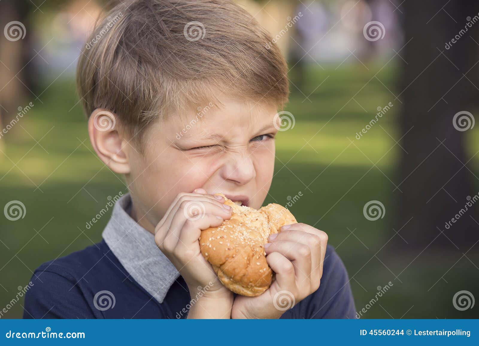 Boy eating a hamburger stock photo. Image of kids, green - 45560244