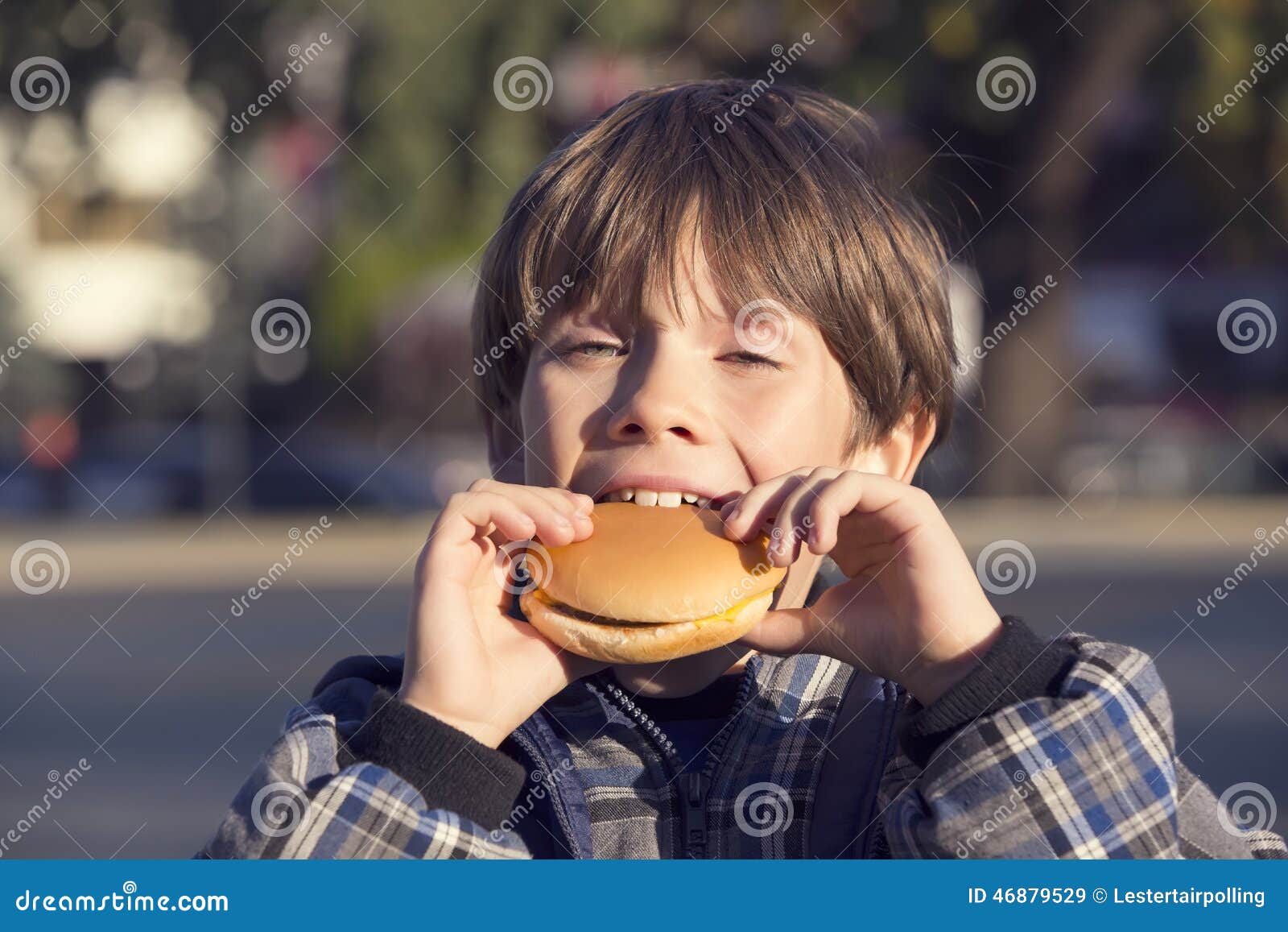 Boy eating a hamburger stock image. Image of lifestyle - 46879529