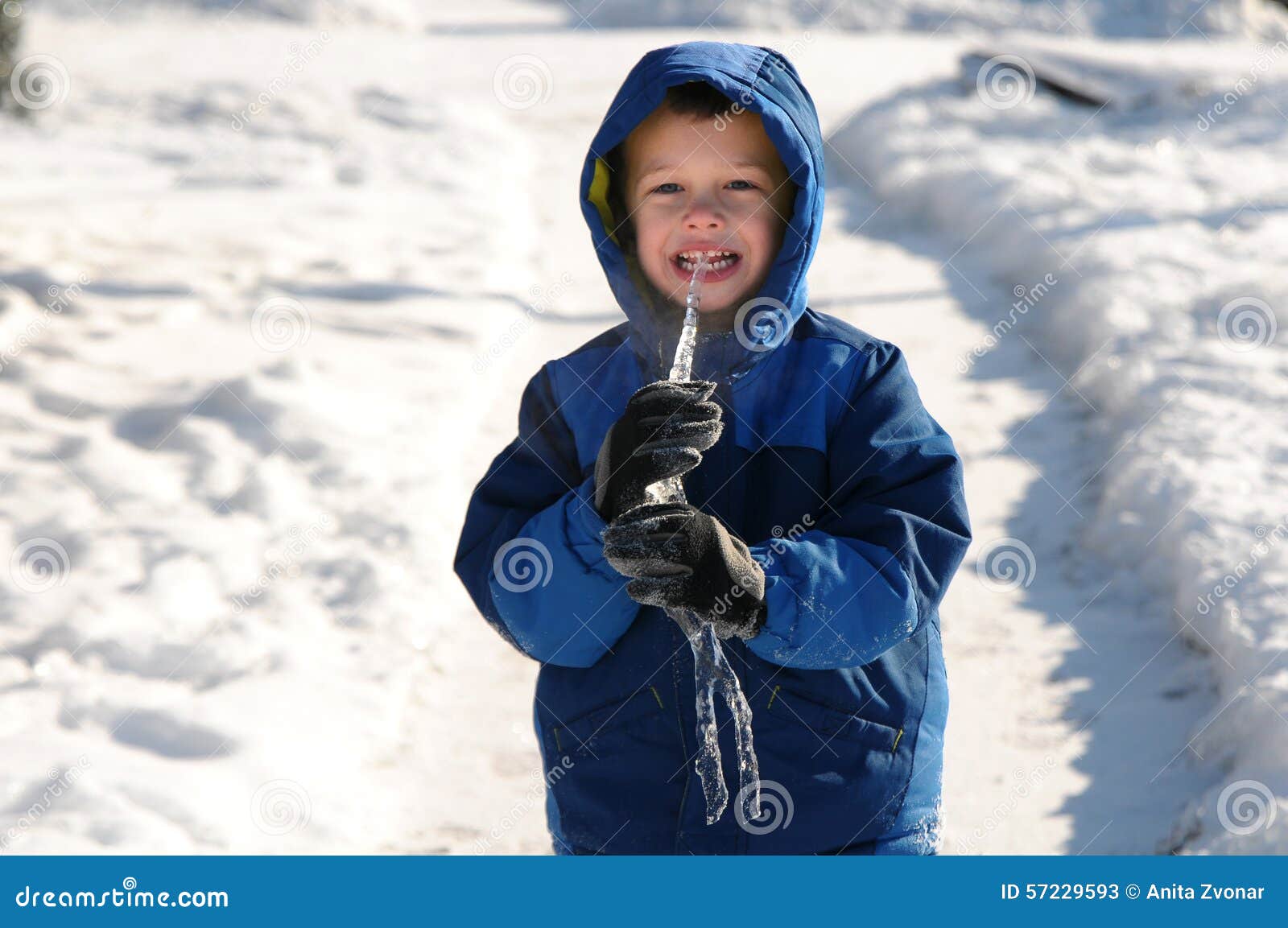 Boy eating Icicle stock image. Image of snow, icicles - 57229593