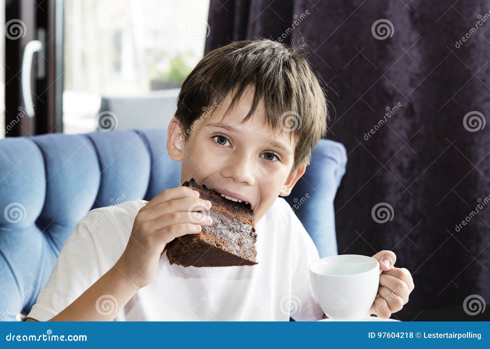 The Boy is Eating a Large Piece of Cake Stock Photo - Image of ...