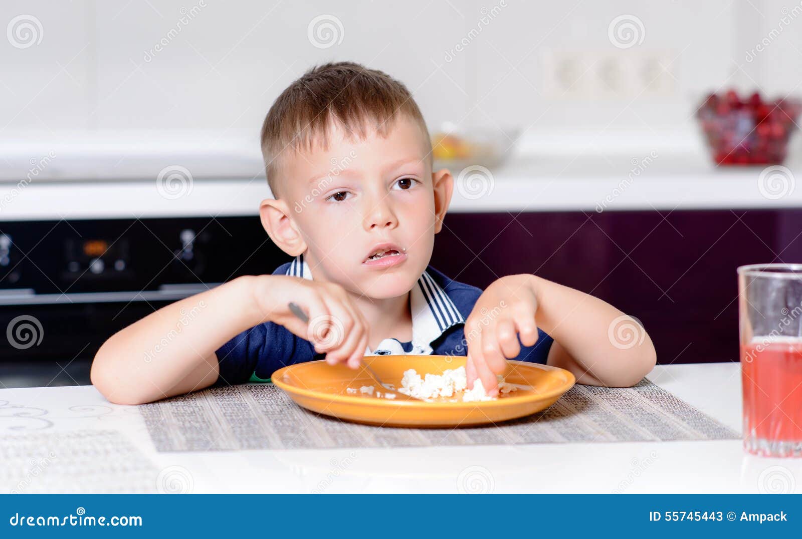 Boy Eating Last Bite of Food at Kitchen Table Stock Image - Image of ...