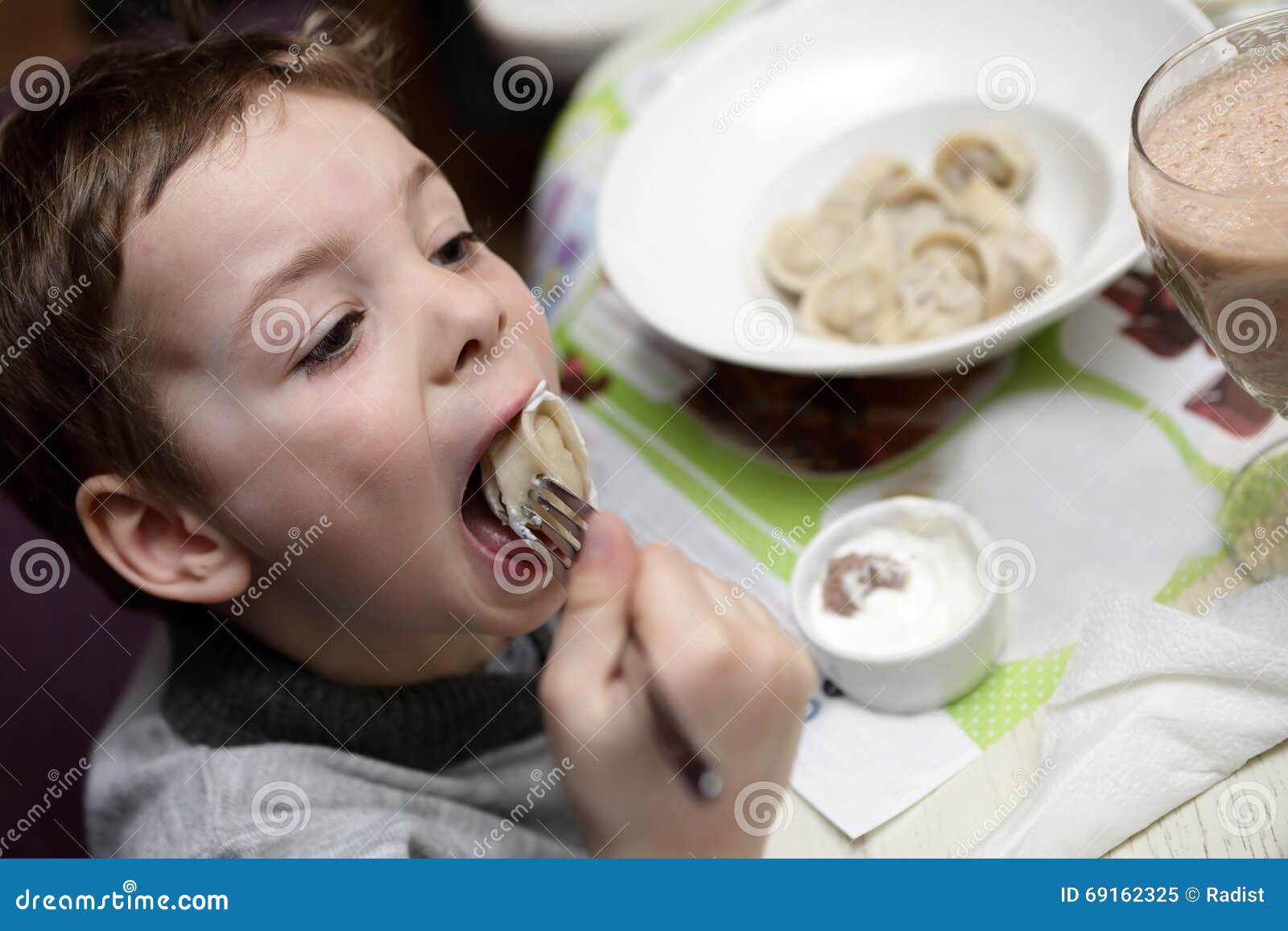 Boy eating meat dumplings stock image. Image of hungry - 69162325