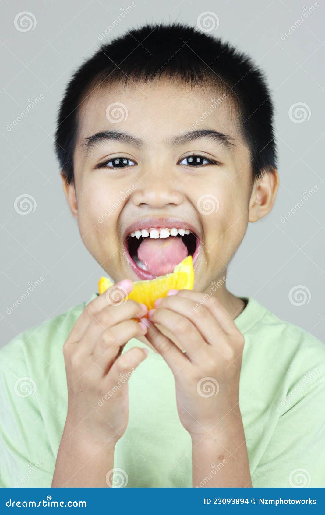 Boy Eating Orange Slice stock photo. Image of dimples - 23093894