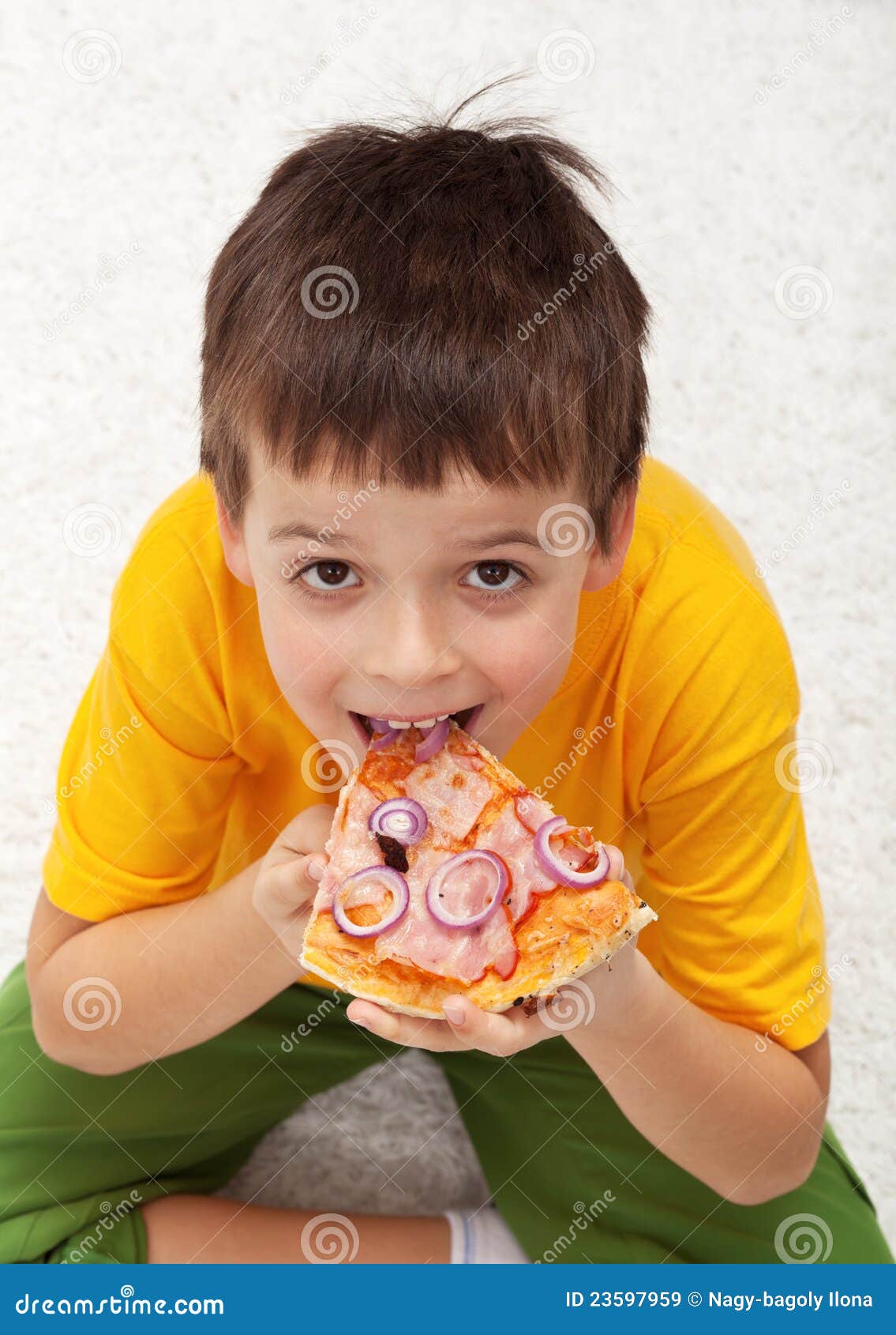 Boy eating pizza stock image. Image of portrait, home - 23597959